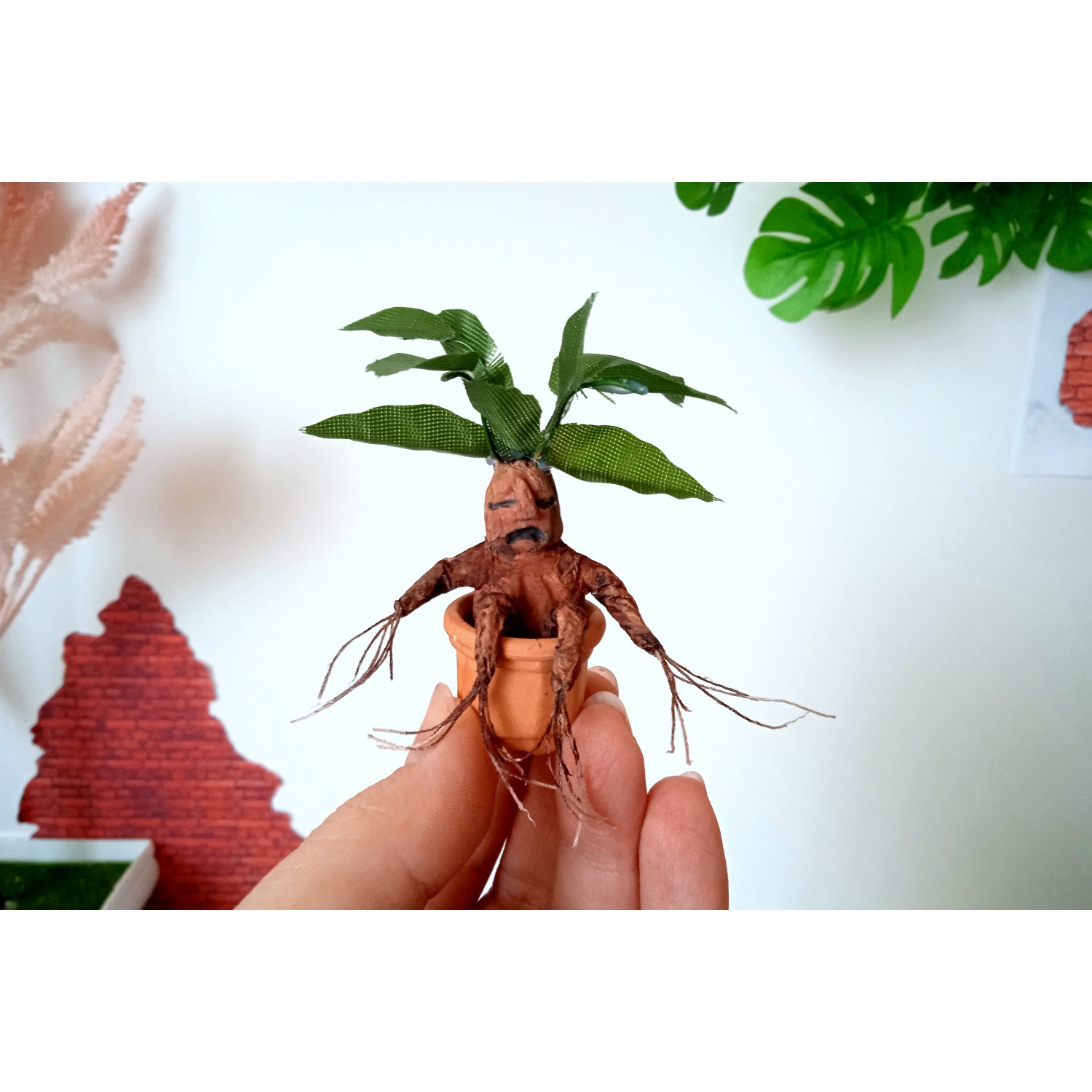 Miniature mandragora root plant in the pot, dollhouse figurine scream