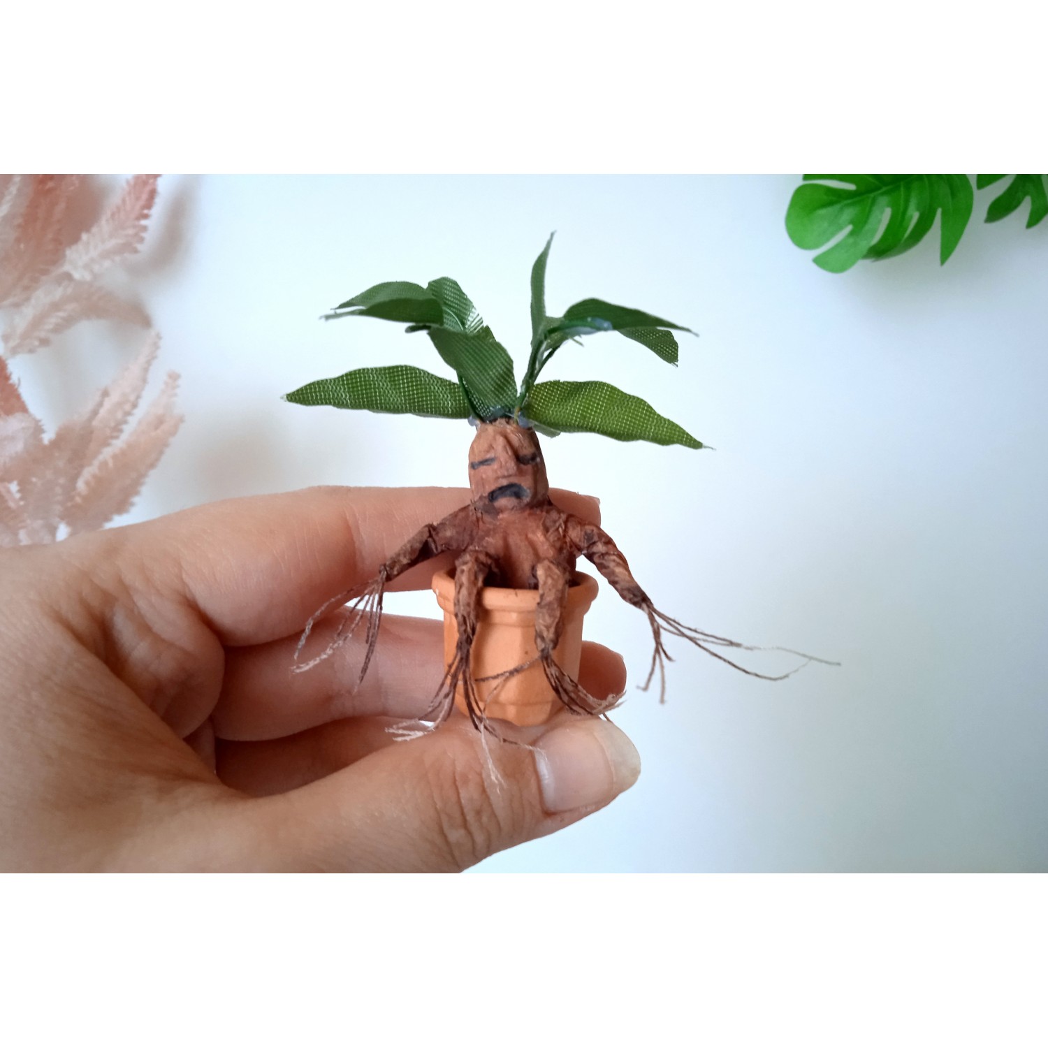 Miniature mandragora root plant in the pot, dollhouse figurine scream